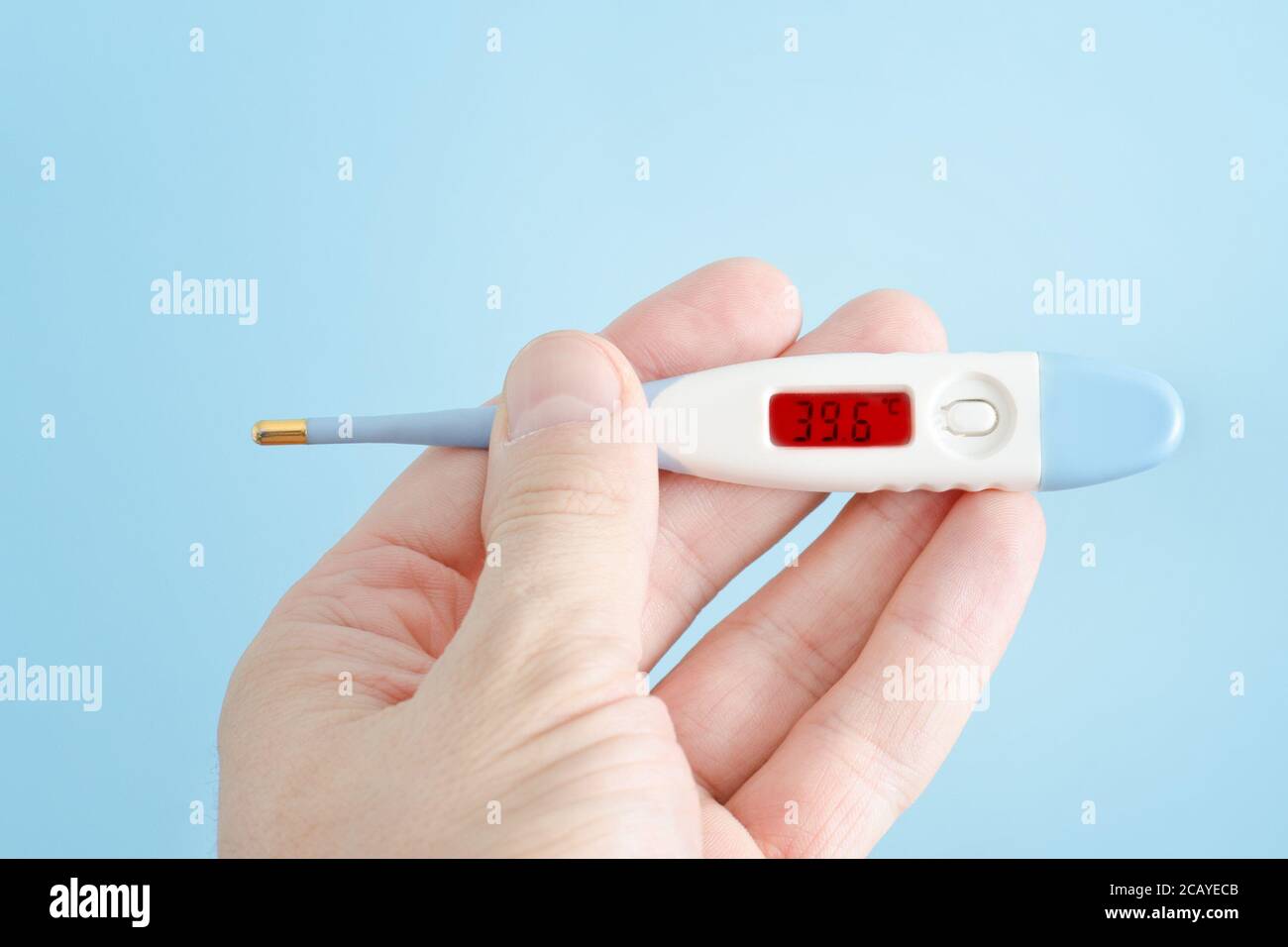 Electronic thermometer in a man's hand. Elevated body temperature ...
