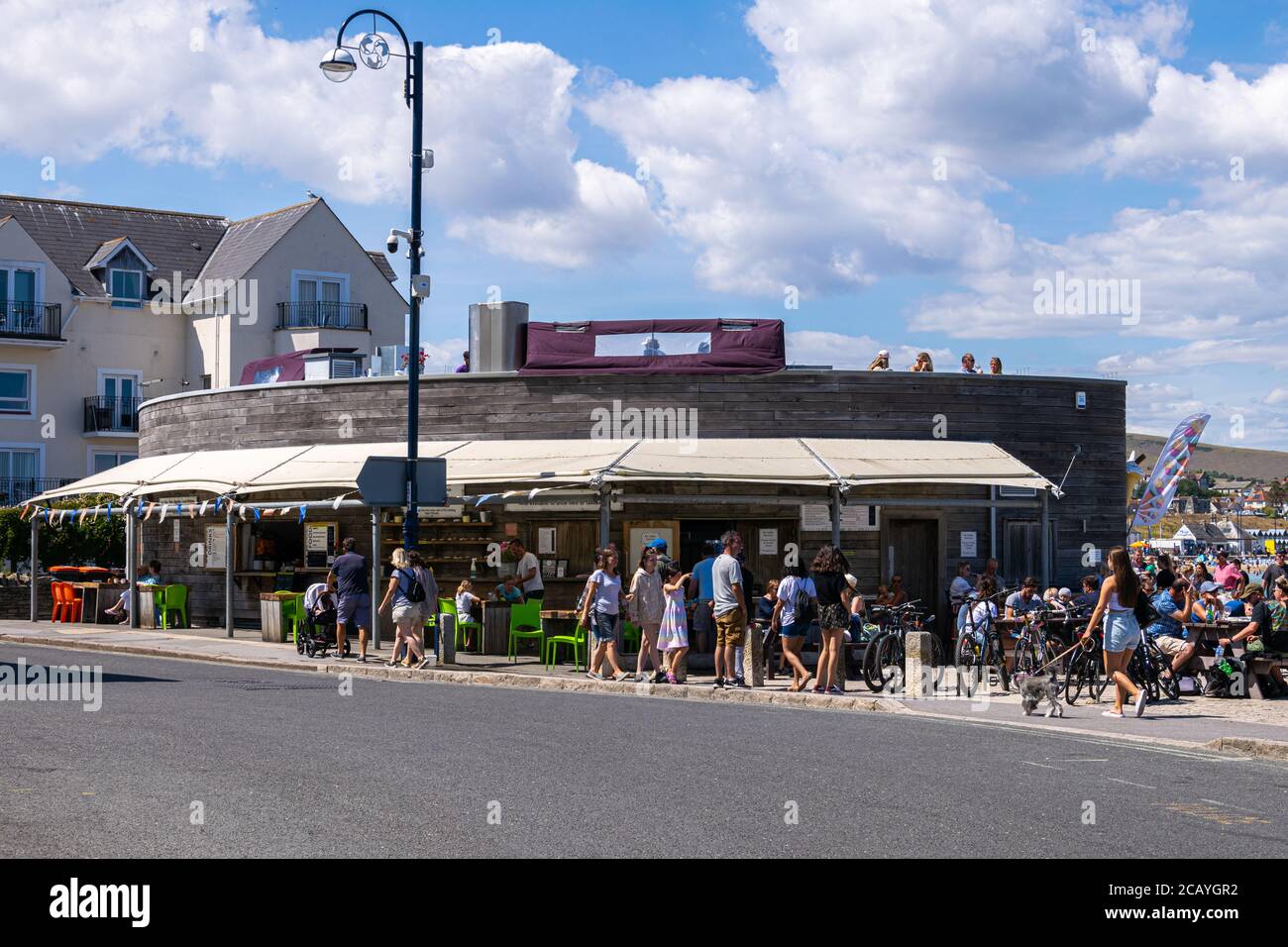 Holiday makes outside the seafood bar at The Old Stone Quay in Swanage ...