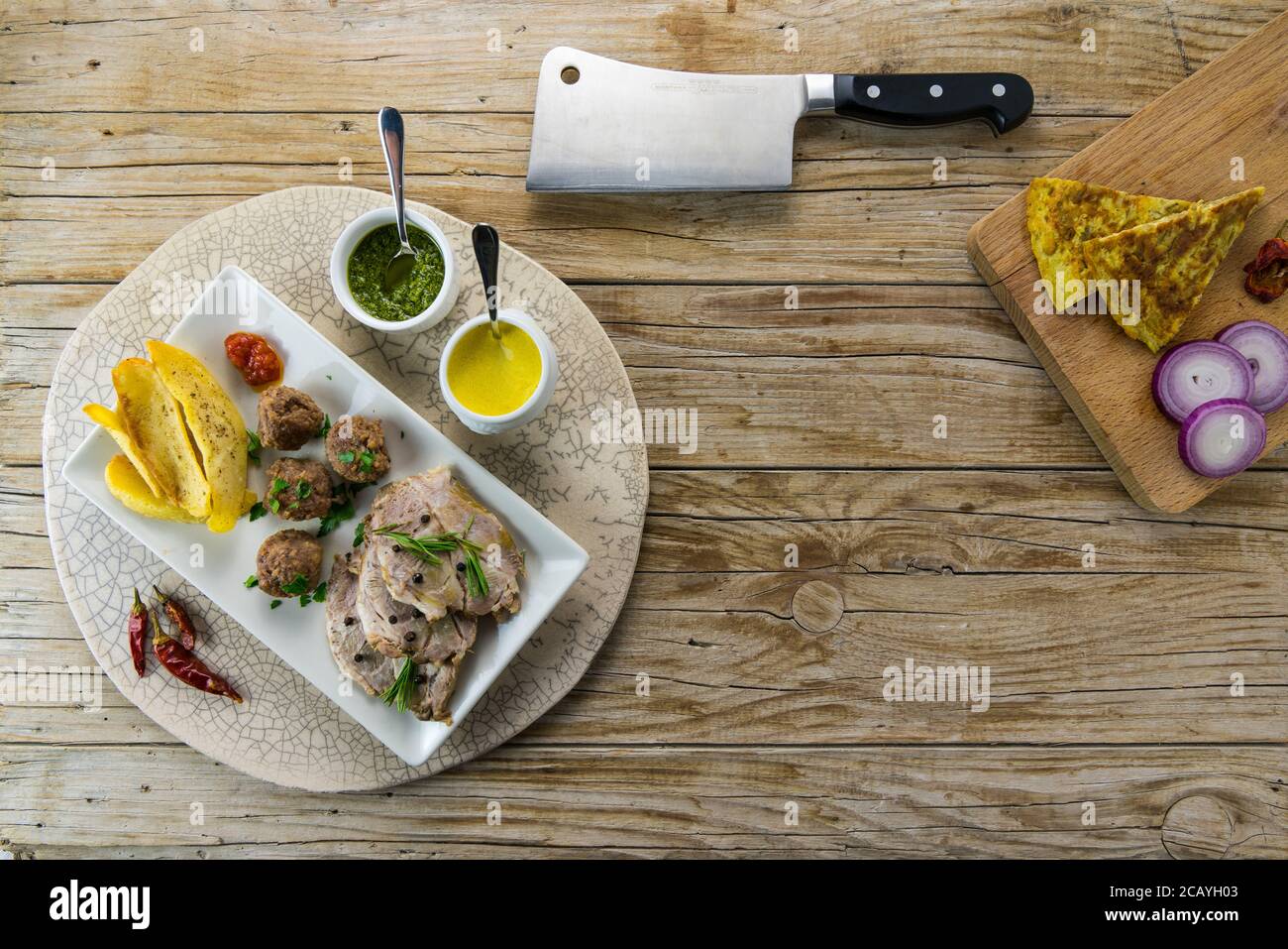 Italian main courses: Top view, copy space with cleaver on wooden table ...