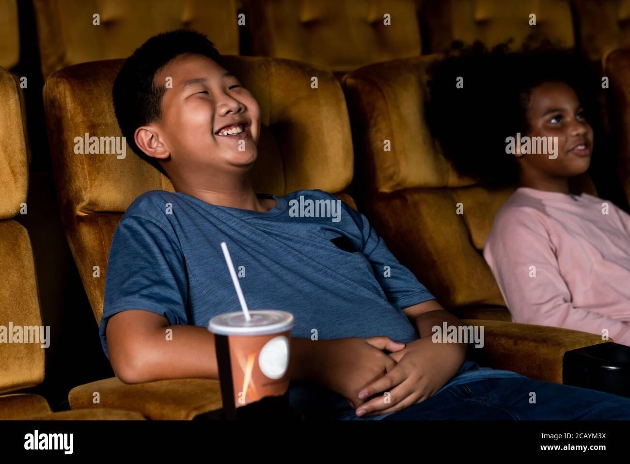 Two children watching cartoon movie hi-res stock photography and images ...
