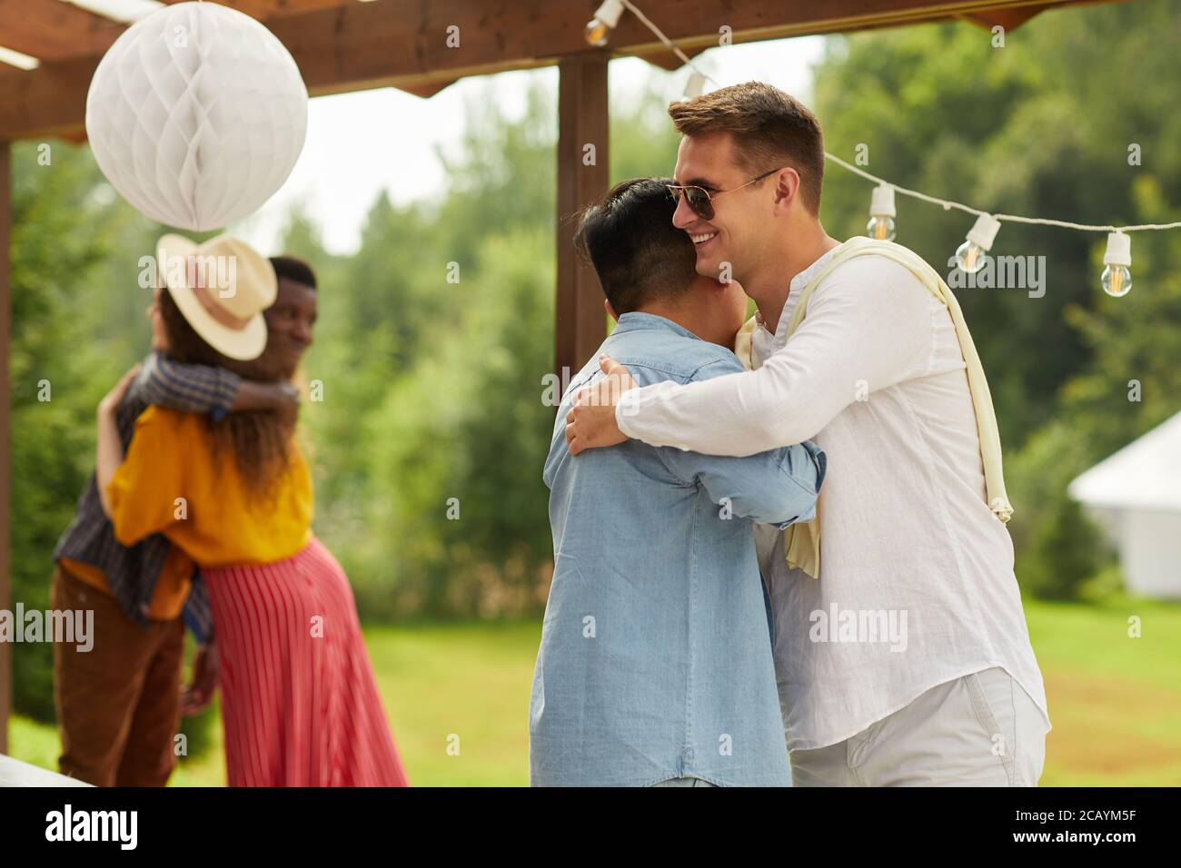 Two men hugging friends hi-res stock photography and images - Alamy