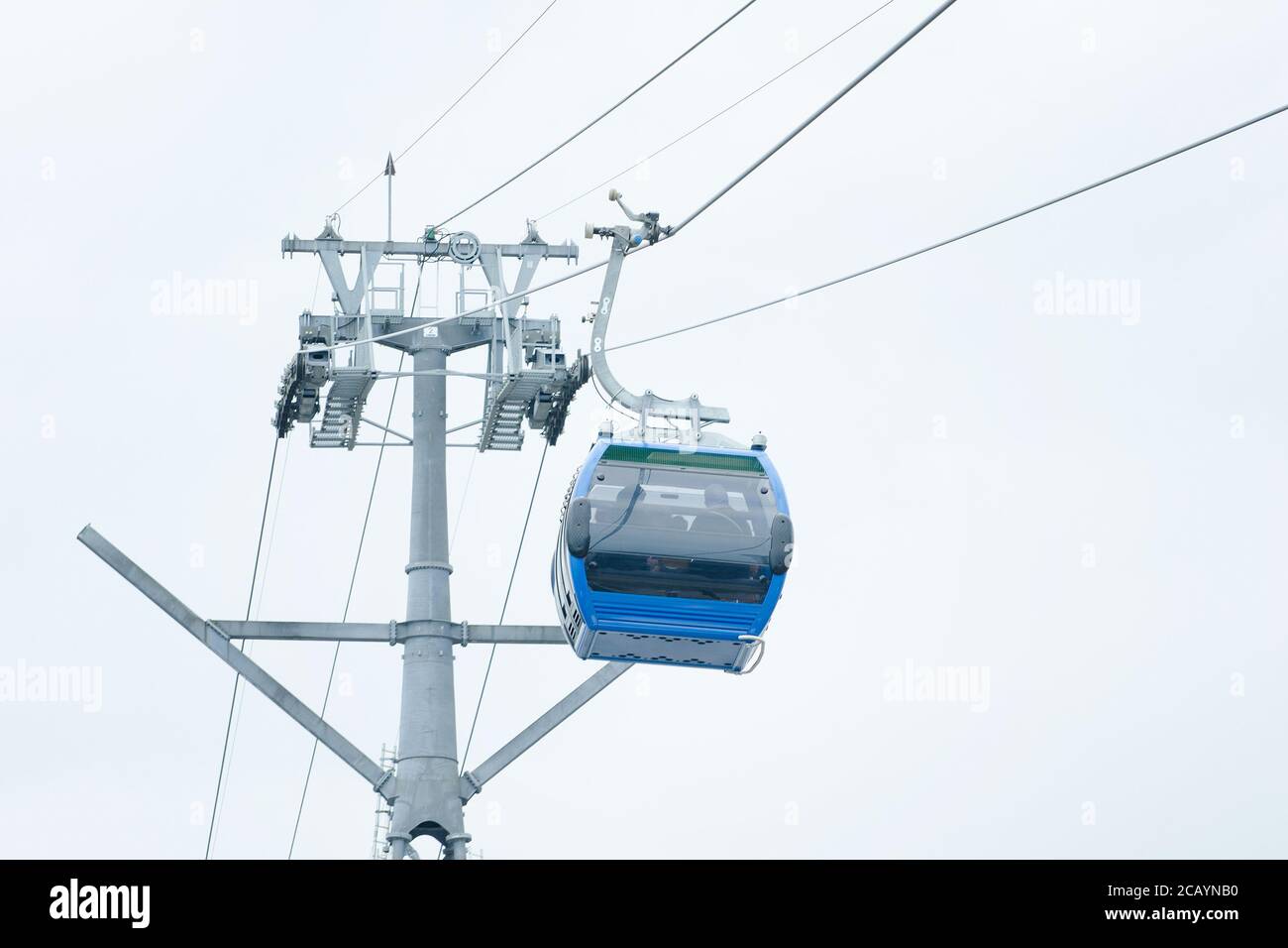 Blue cabin cable car at the tower. Bottom view Stock Photo - Alamy