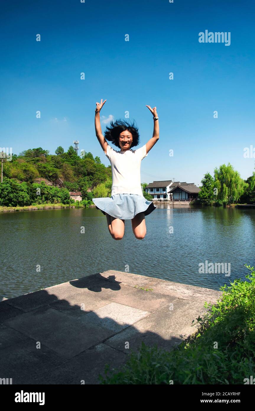 Asian jumping happy sky hi-res stock photography and images - Alamy