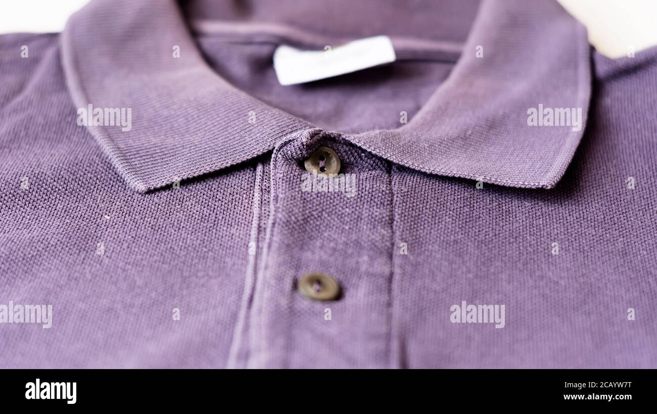 Detail of the collar and buttons of a purple polo shirt. Sportswear and ...