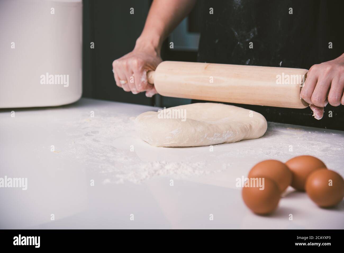 Hand of baker woman female making dough pastry pie with rolling wooden ...
