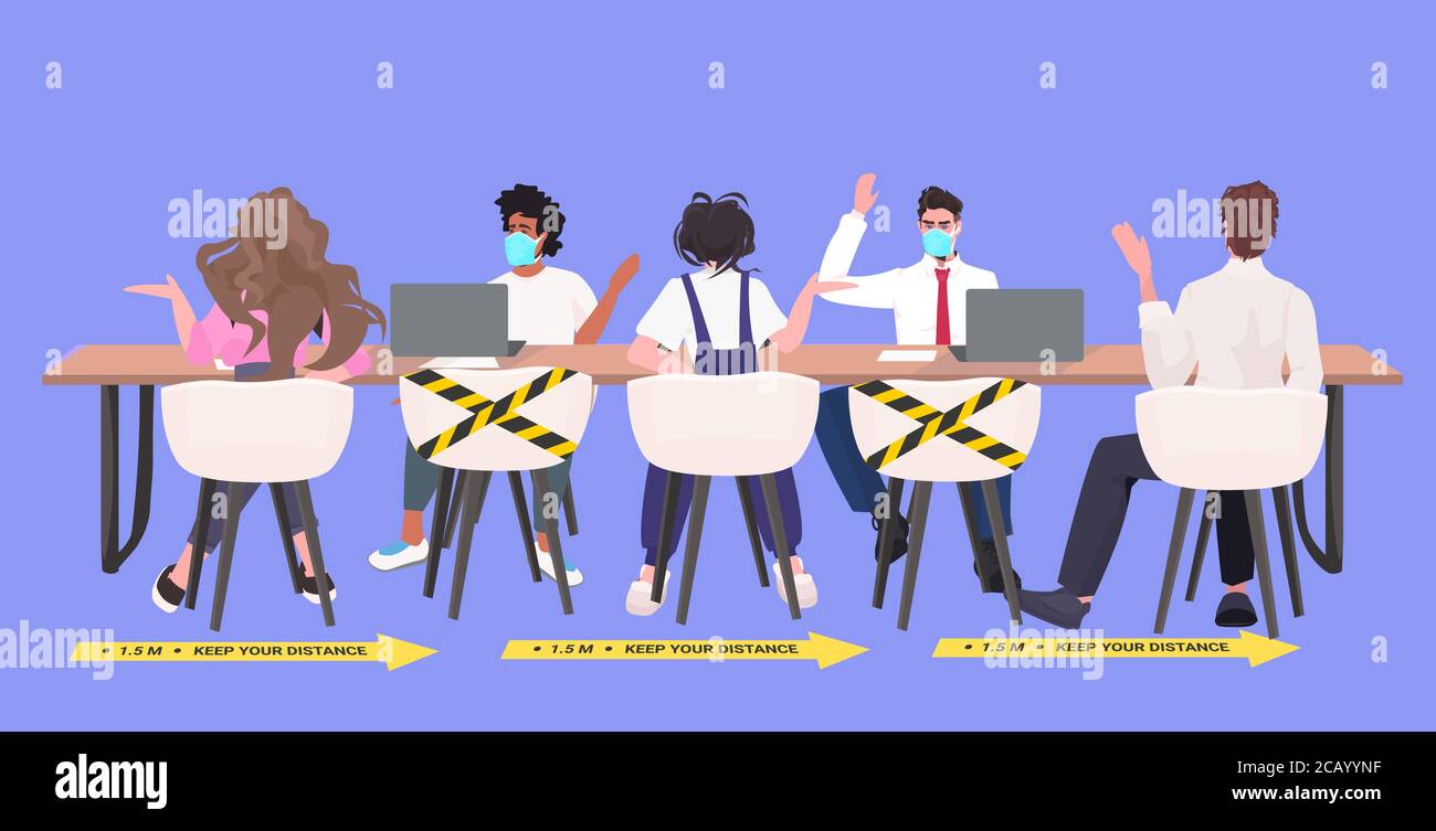 businesspeople sitting at round table keeping distance to prevent ...