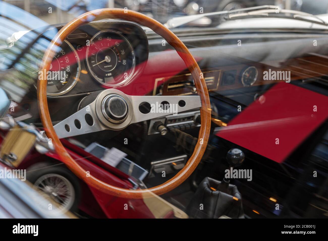 Unique decorated shiny and wooden steering wheel and blur dashboard ...