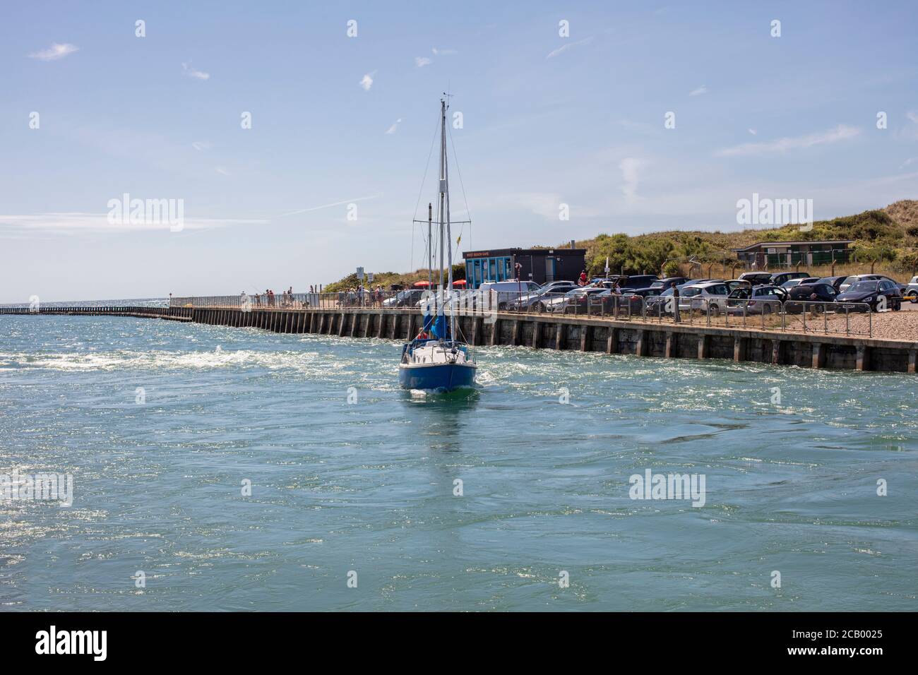 Small yacht entering the mouth of the River Arun at Littlehampton, West ...