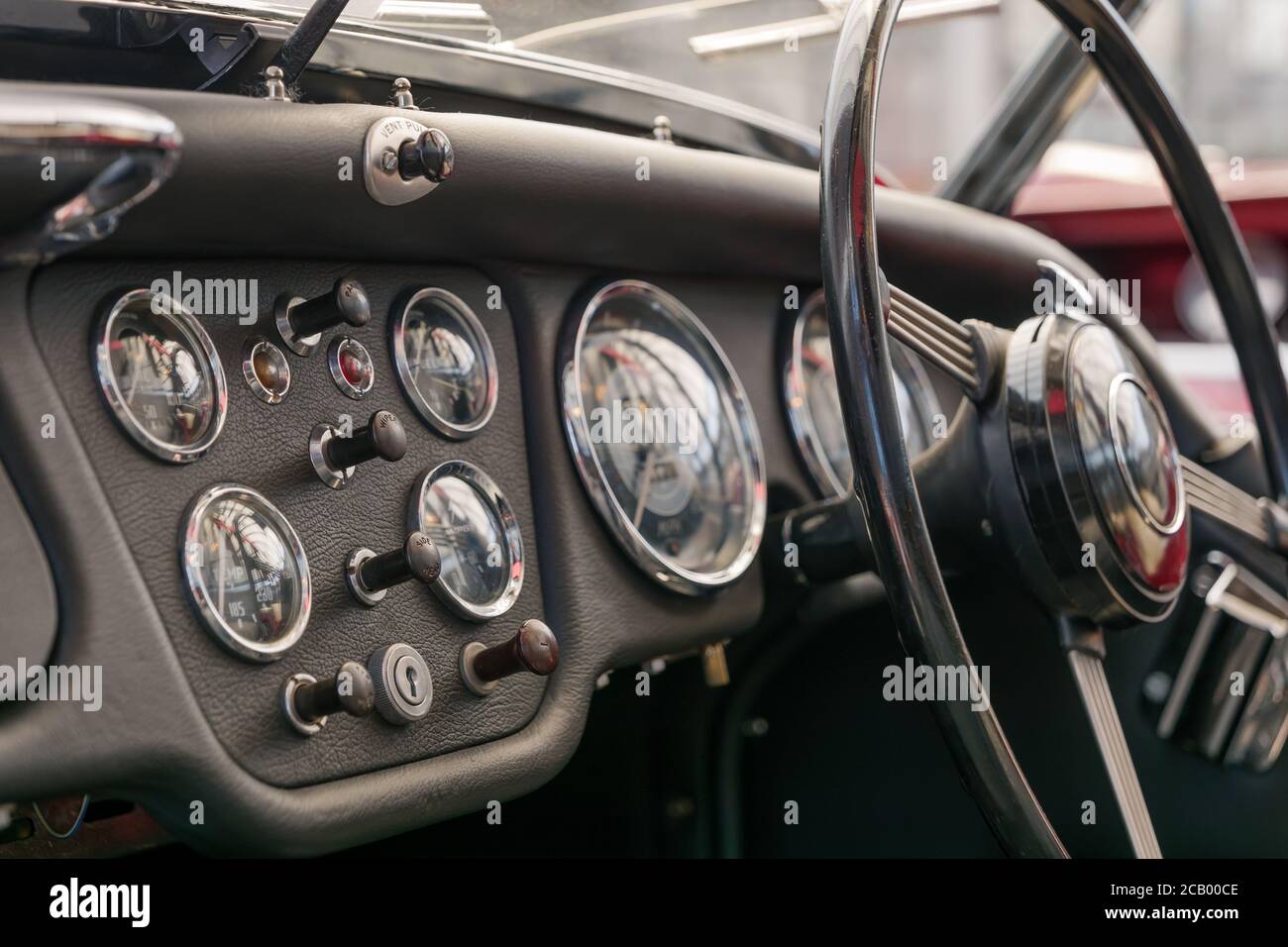 Vintage detail of gauge, switches, button, meter and steering wheel on ...