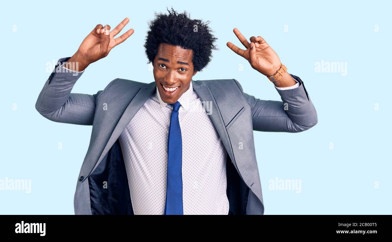 Handsome african american man with afro hair wearing business jacket ...