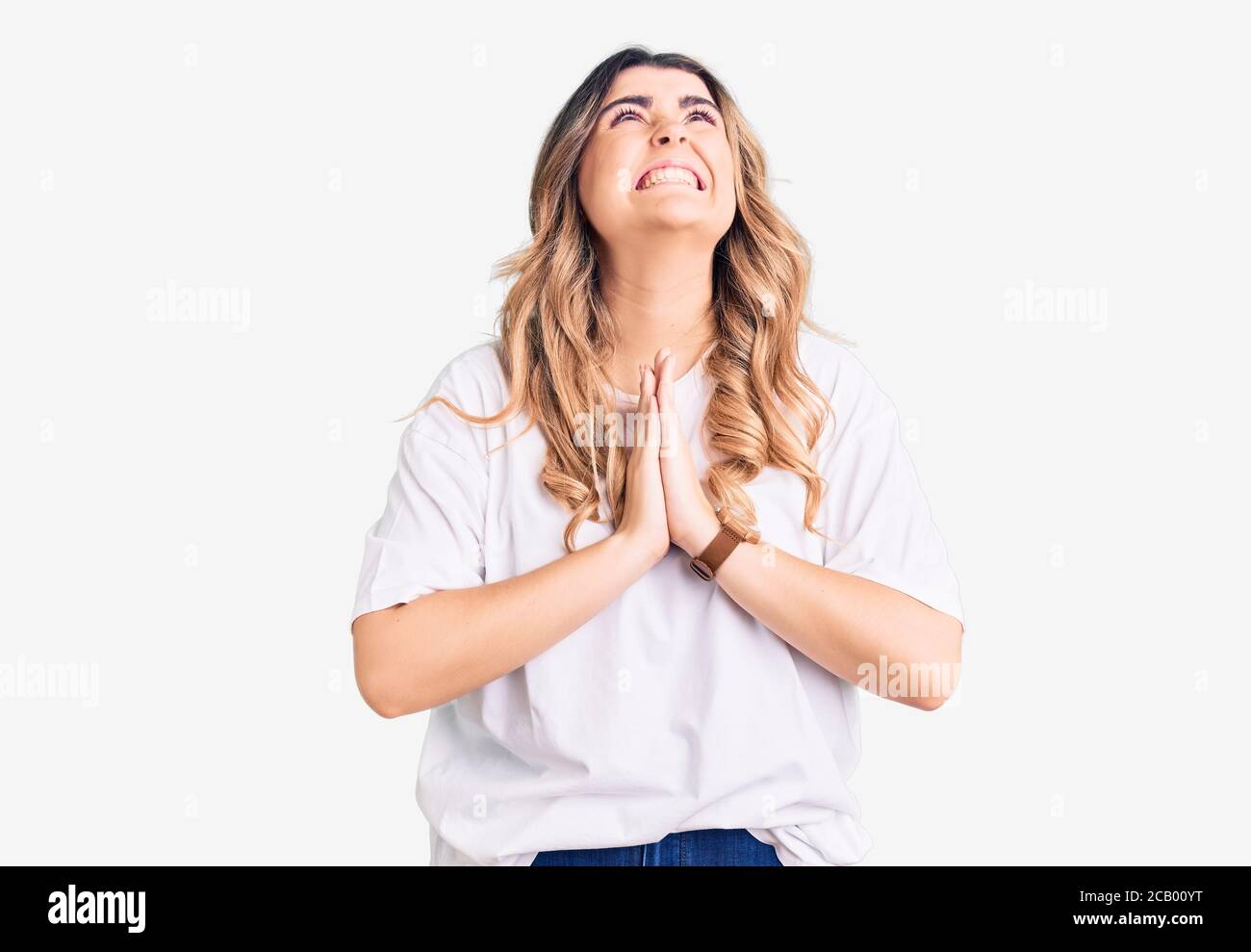 Young caucasian woman wearing casual clothes begging and praying with ...
