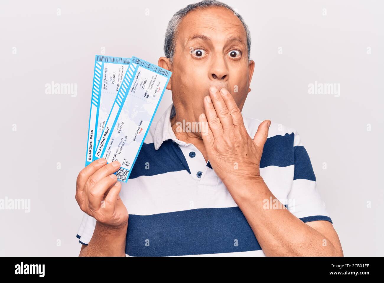 Senior handsome grey-haired man holding airline boarding pass over ...