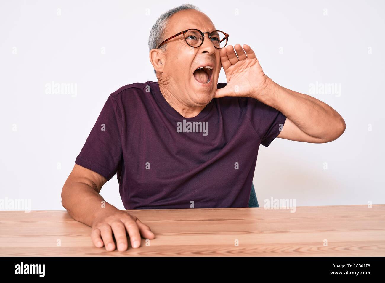 Senior handsome man with gray hair wearing casual clothes and glasses ...
