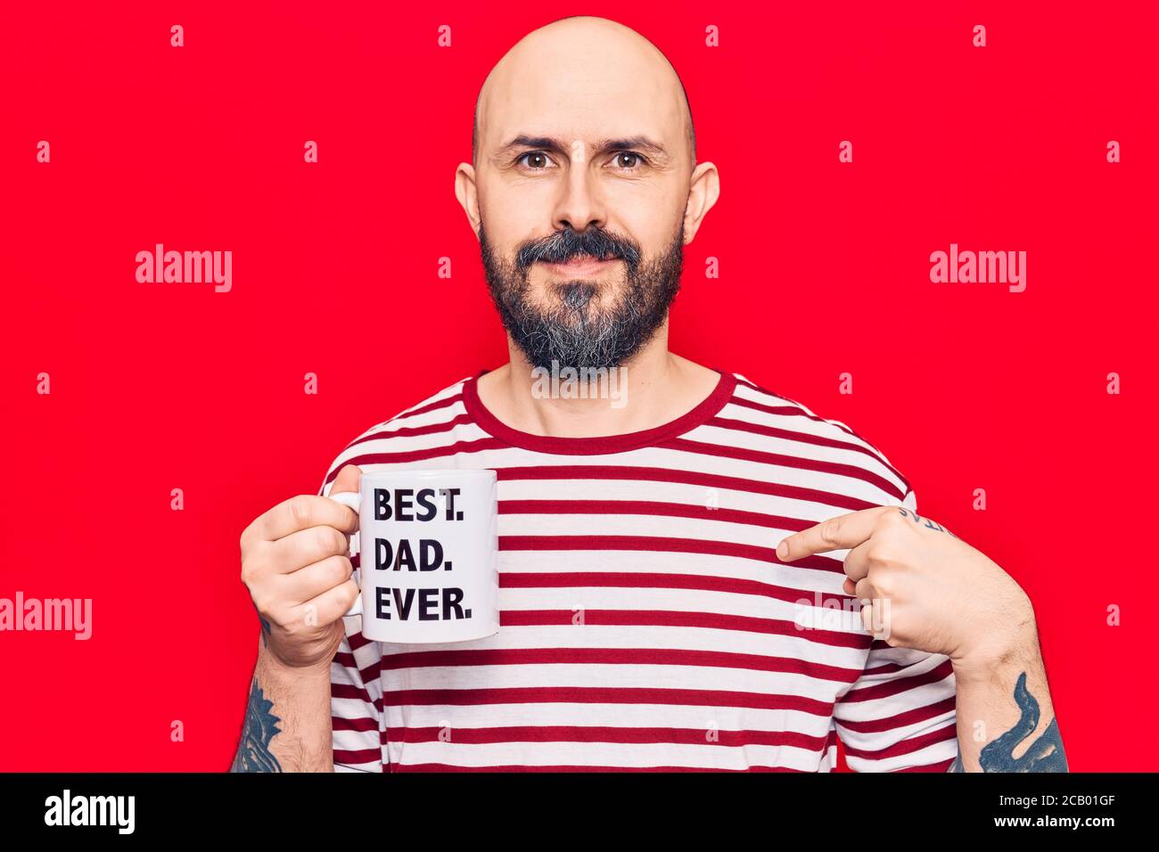 Young handsome man drinking mug of coffe with best dad ever message ...