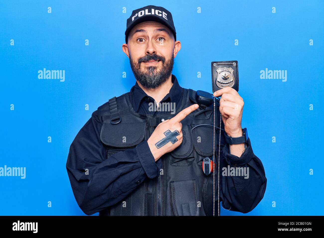 Young handsome man wearing police uniform holding gun smiling happy ...