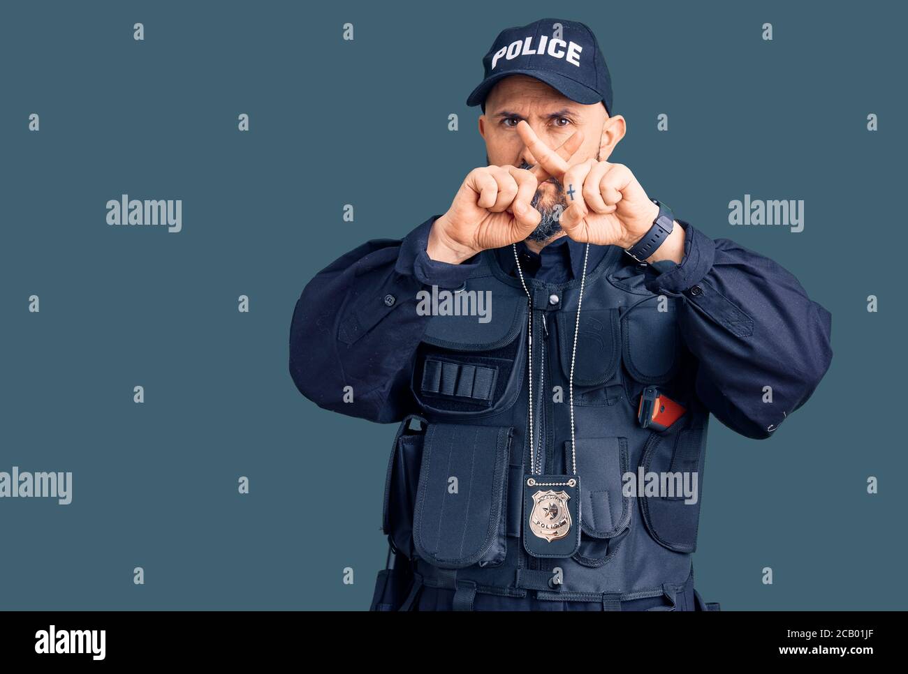 Young handsome man wearing police uniform rejection expression crossing ...