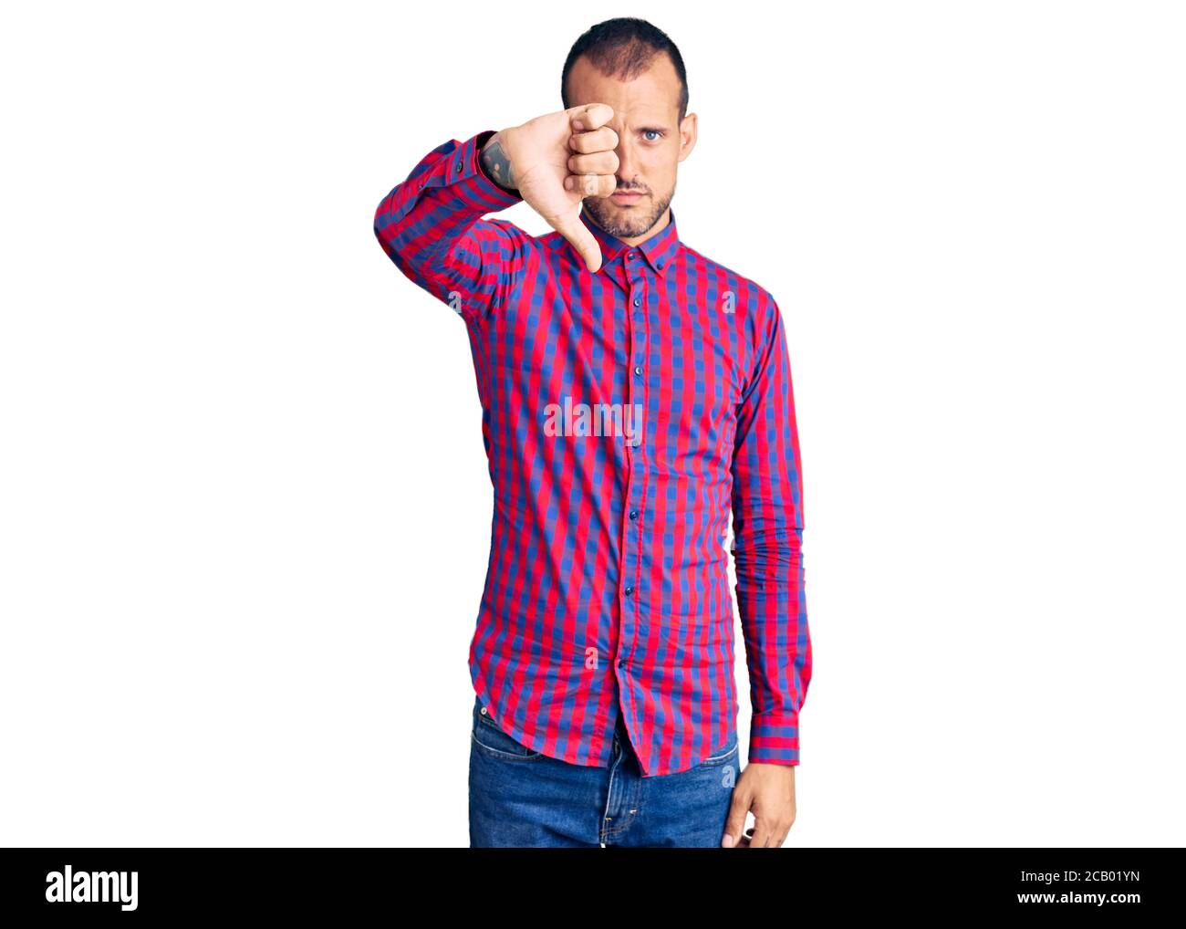 Young handsome man wearing casual clothes looking unhappy and angry ...