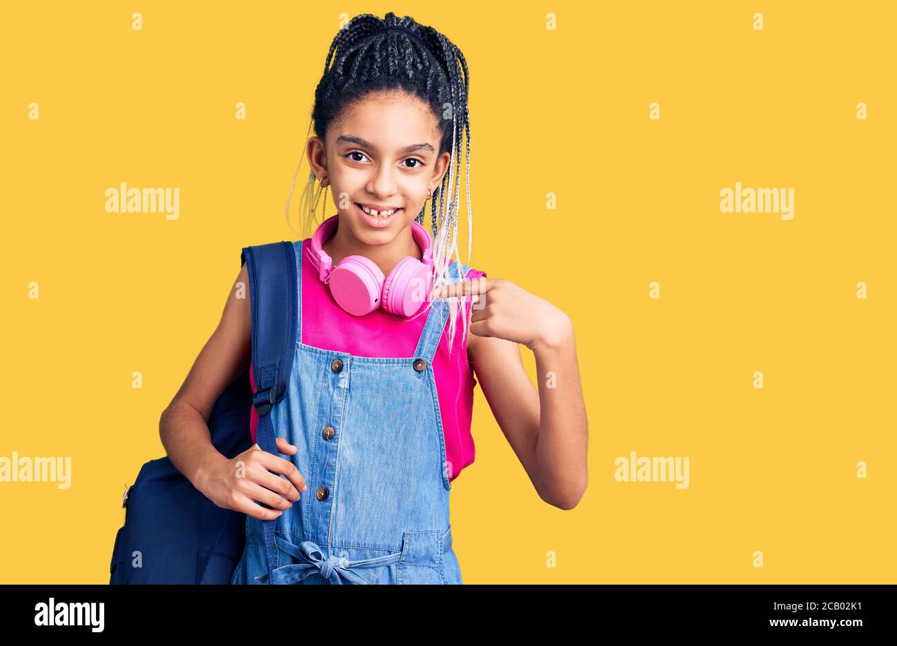Cute african american girl holding student backpack using backpack ...