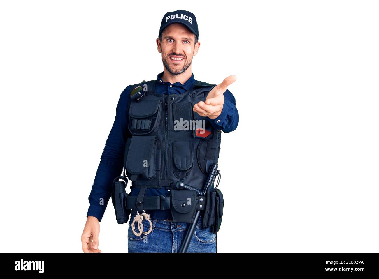 Young handsome man wearing police uniform smiling cheerful offering ...