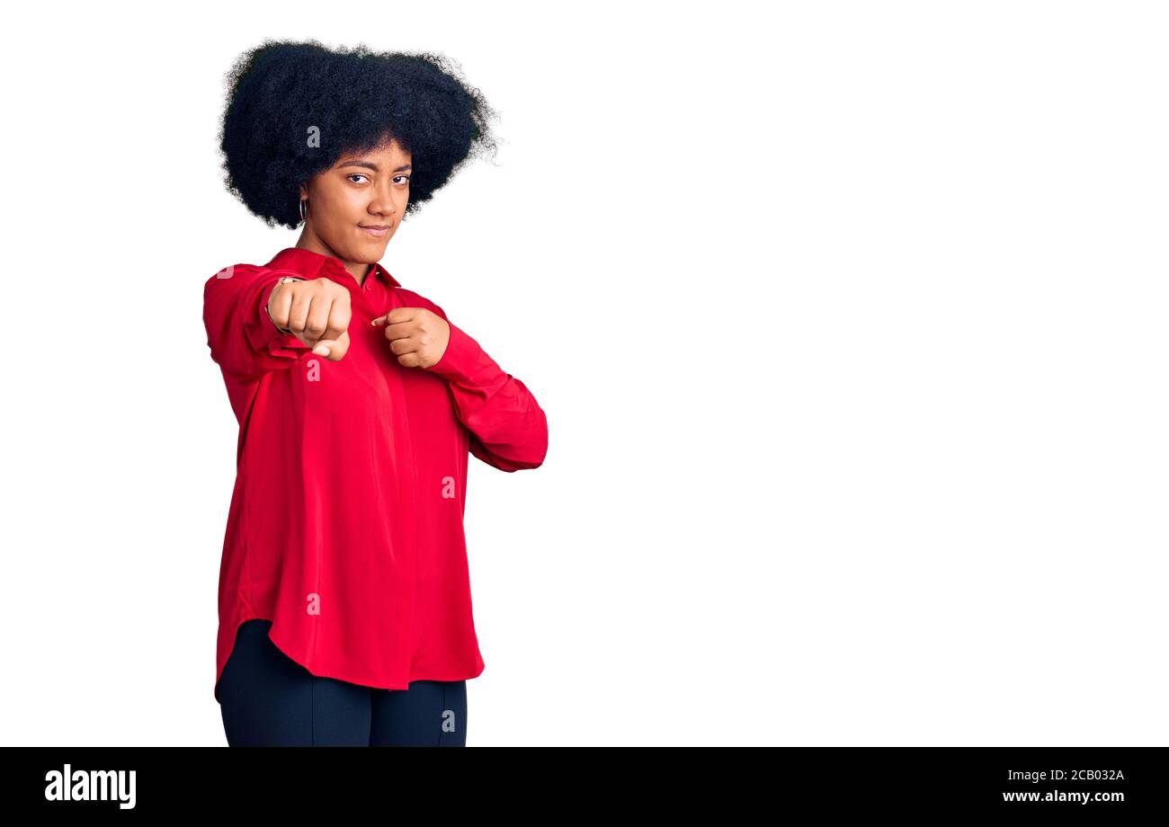 Young african american girl wearing casual clothes punching fist to ...