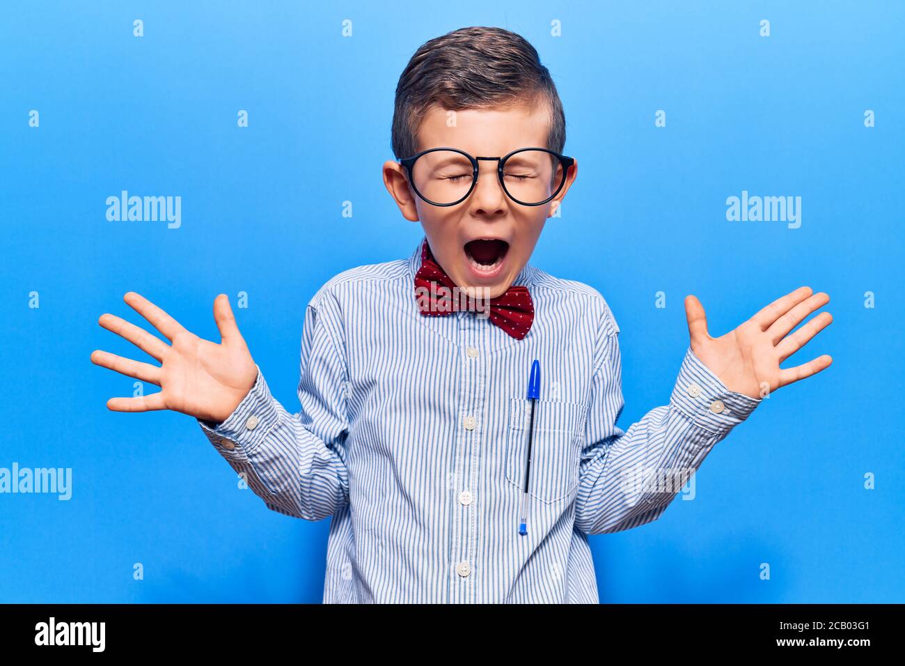 Cute blond kid wearing nerd bow tie and glasses celebrating mad and ...