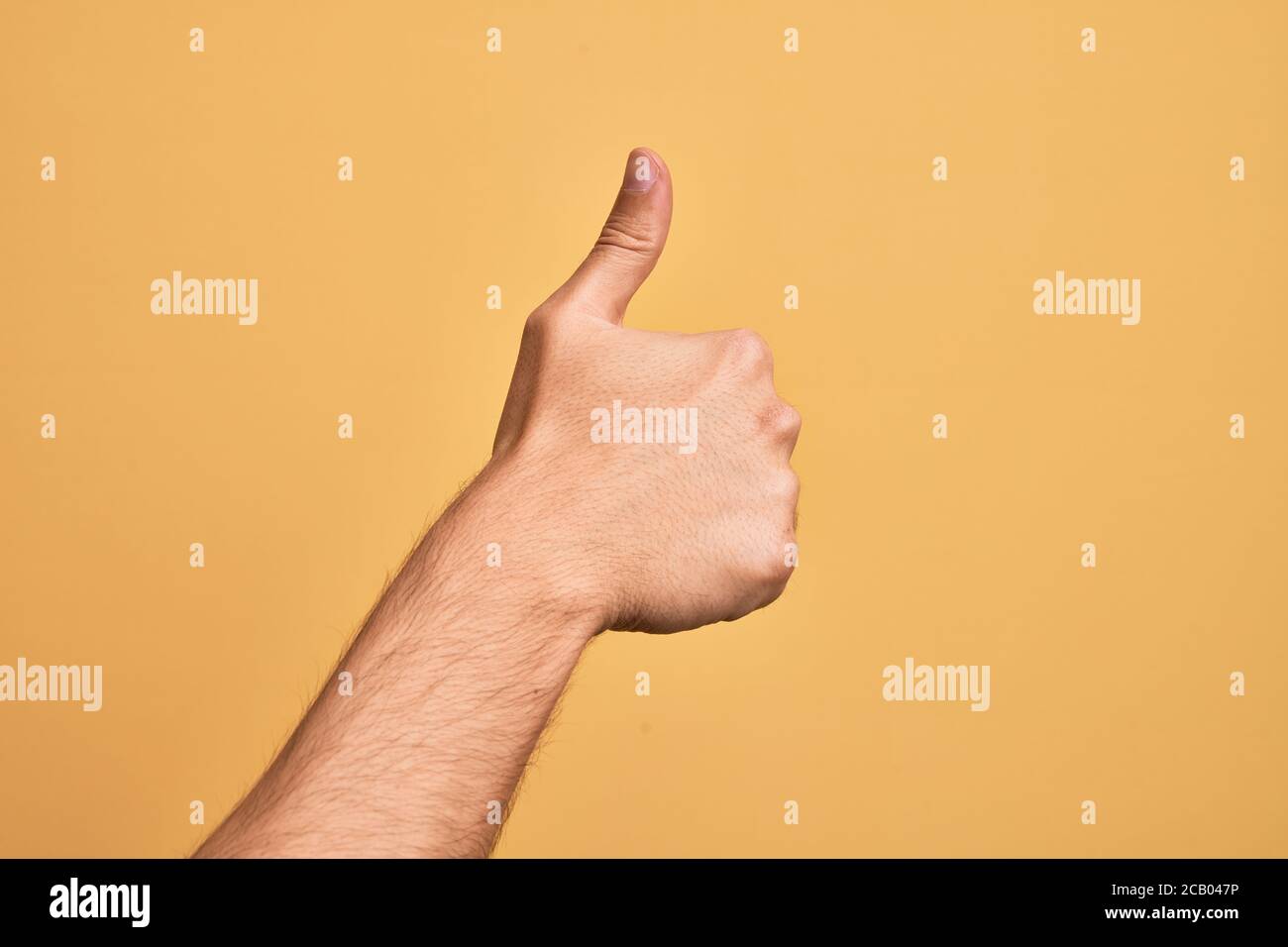 Hand of caucasian young man showing fingers over isolated yellow ...