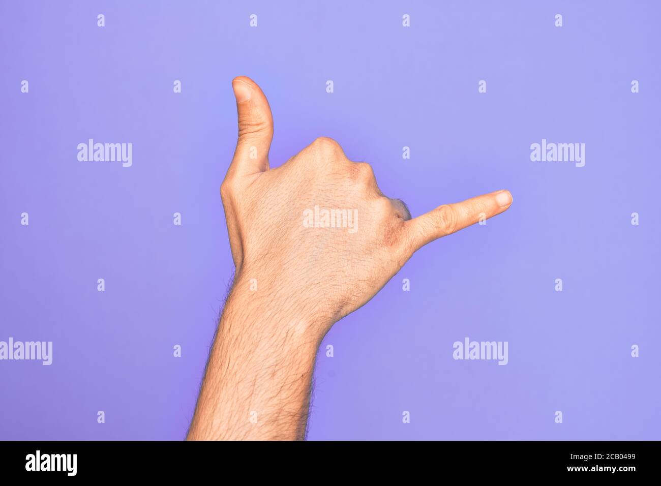 Hand of caucasian young man showing fingers over isolated purple ...