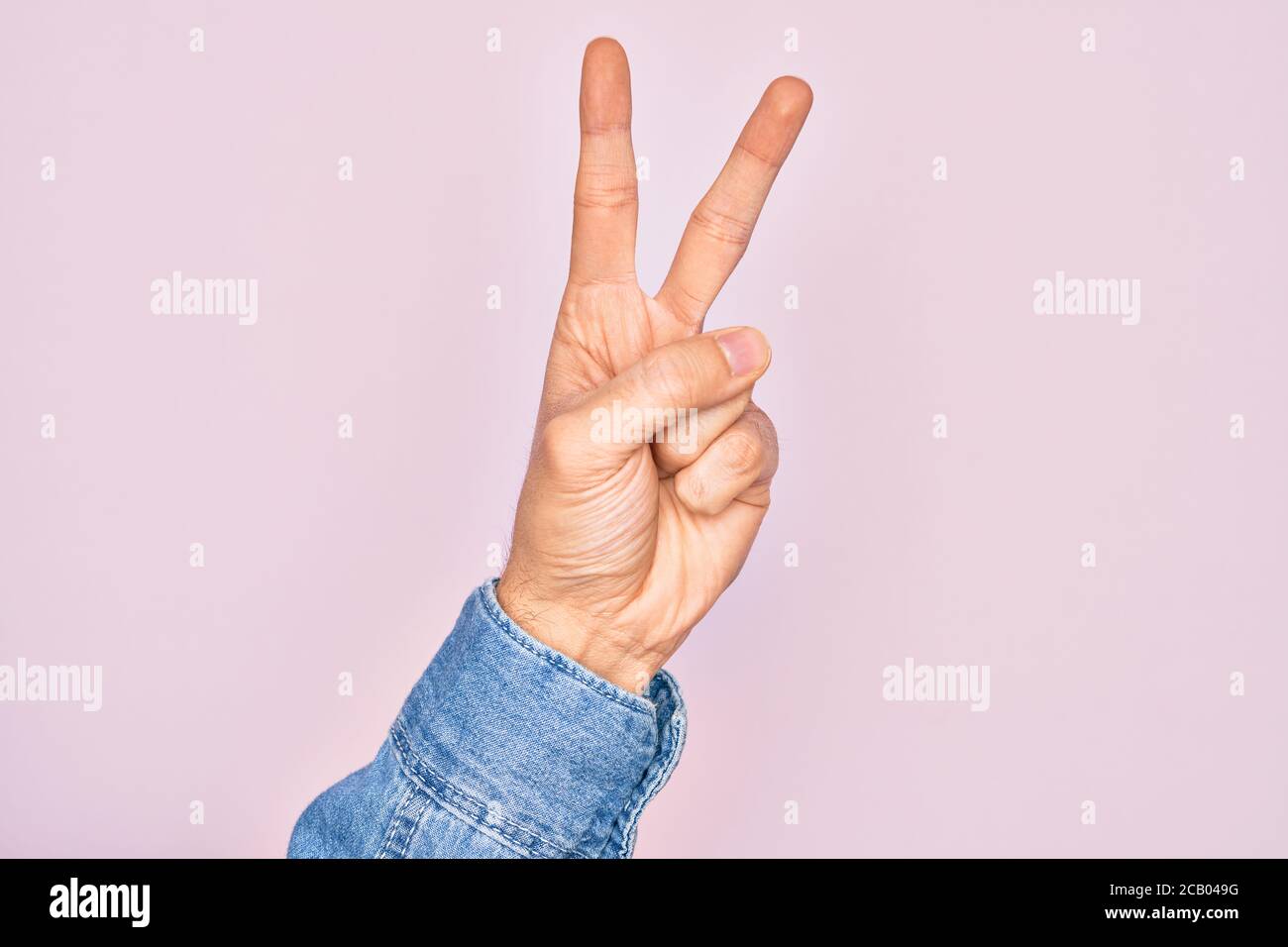 Hand of caucasian young man showing fingers over isolated pink ...