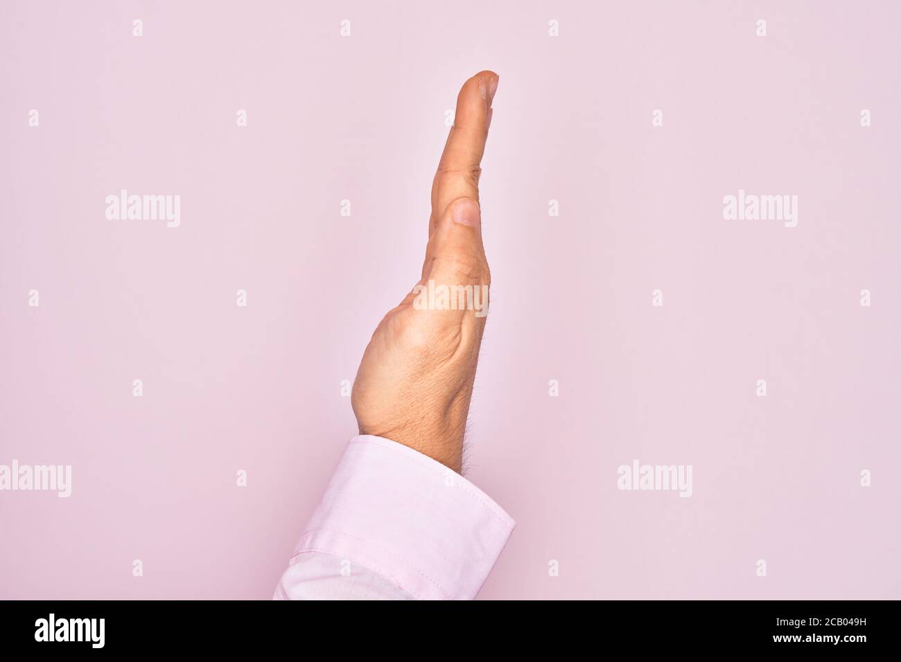 Hand of caucasian young man showing fingers over isolated pink ...