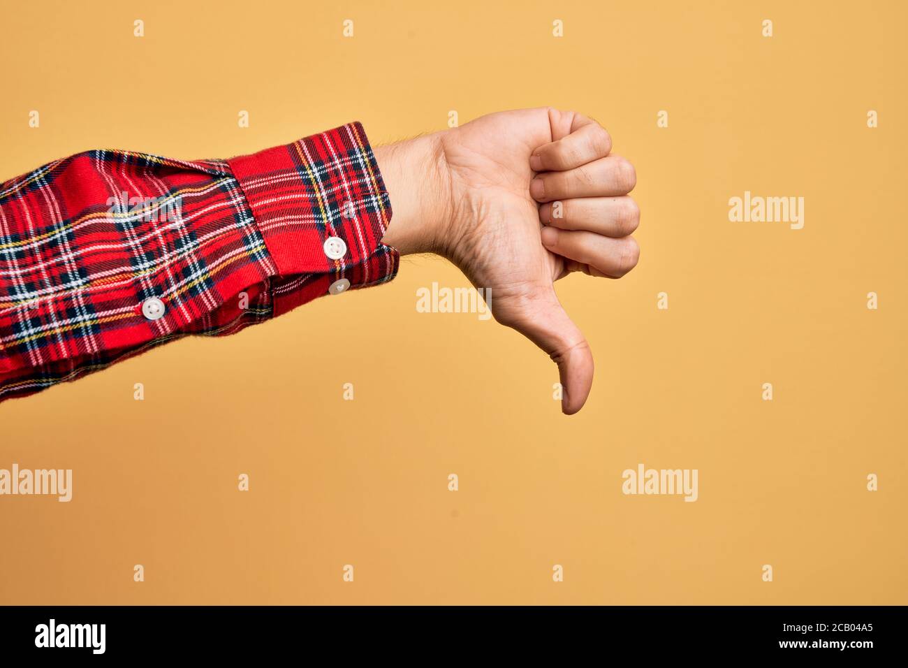 Hand of caucasian young man showing fingers over isolated yellow ...
