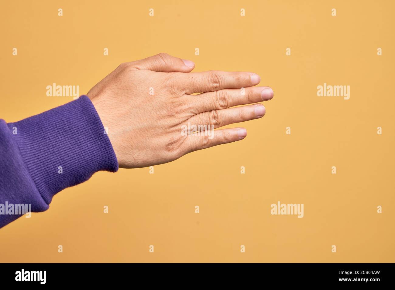 Hand of caucasian young man showing fingers over isolated yellow ...