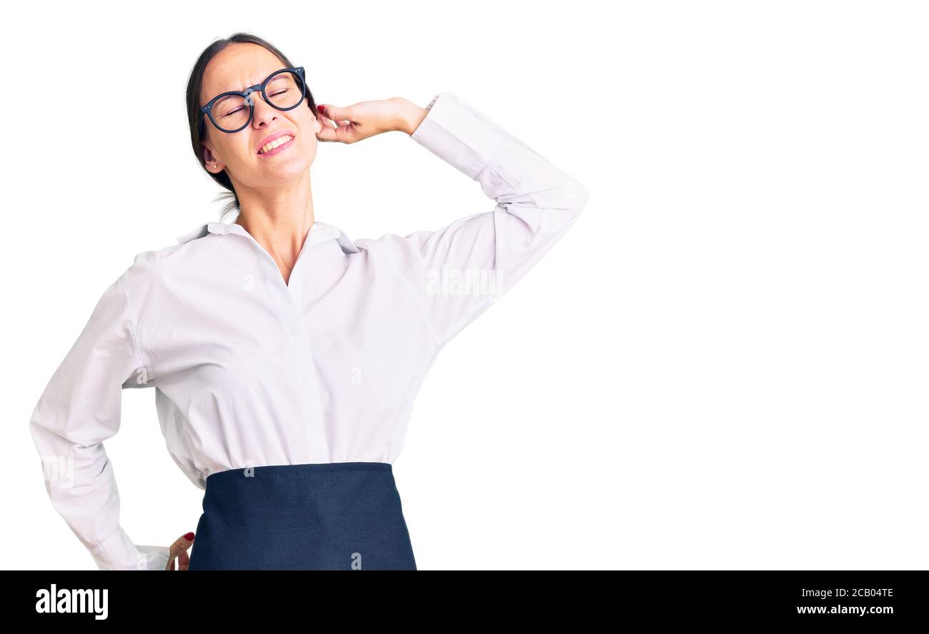 Beautiful brunette young woman wearing professional waitress apron ...