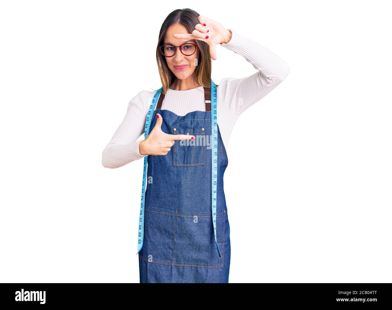 Beautiful brunette young woman dressmaker designer wearing atelier ...