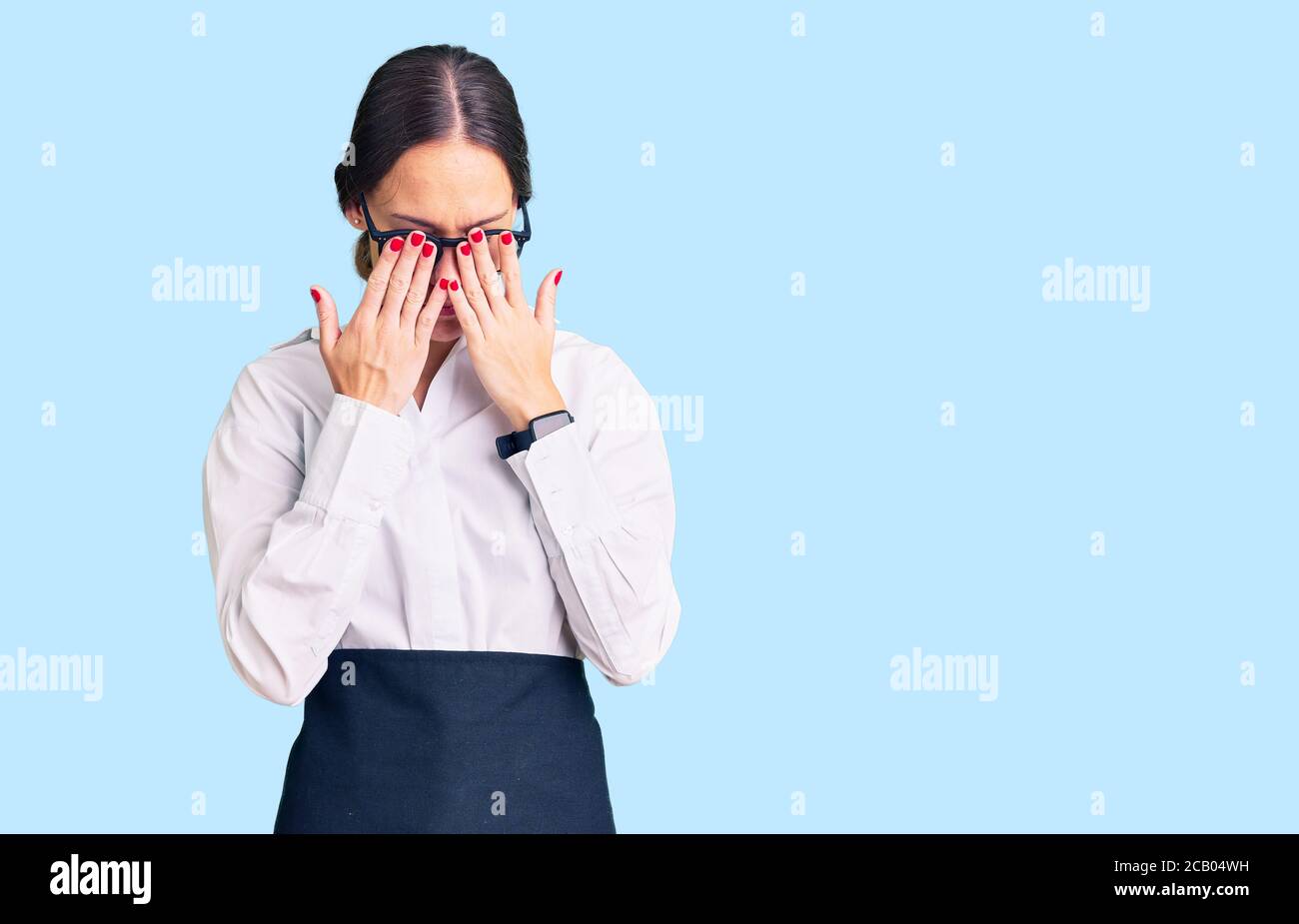 Beautiful brunette young woman wearing professional waitress apron ...