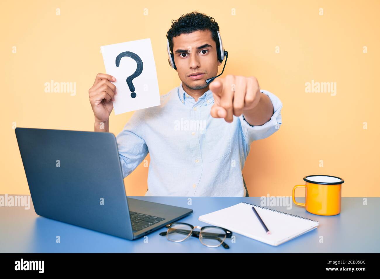 Young handsome hispanic man holding question mark as customer support ...