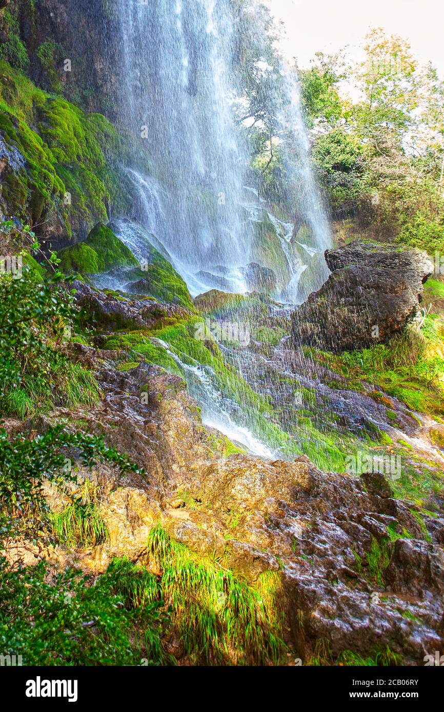 Natural waterfall in the mountain . Cascade water flows on the rock ...