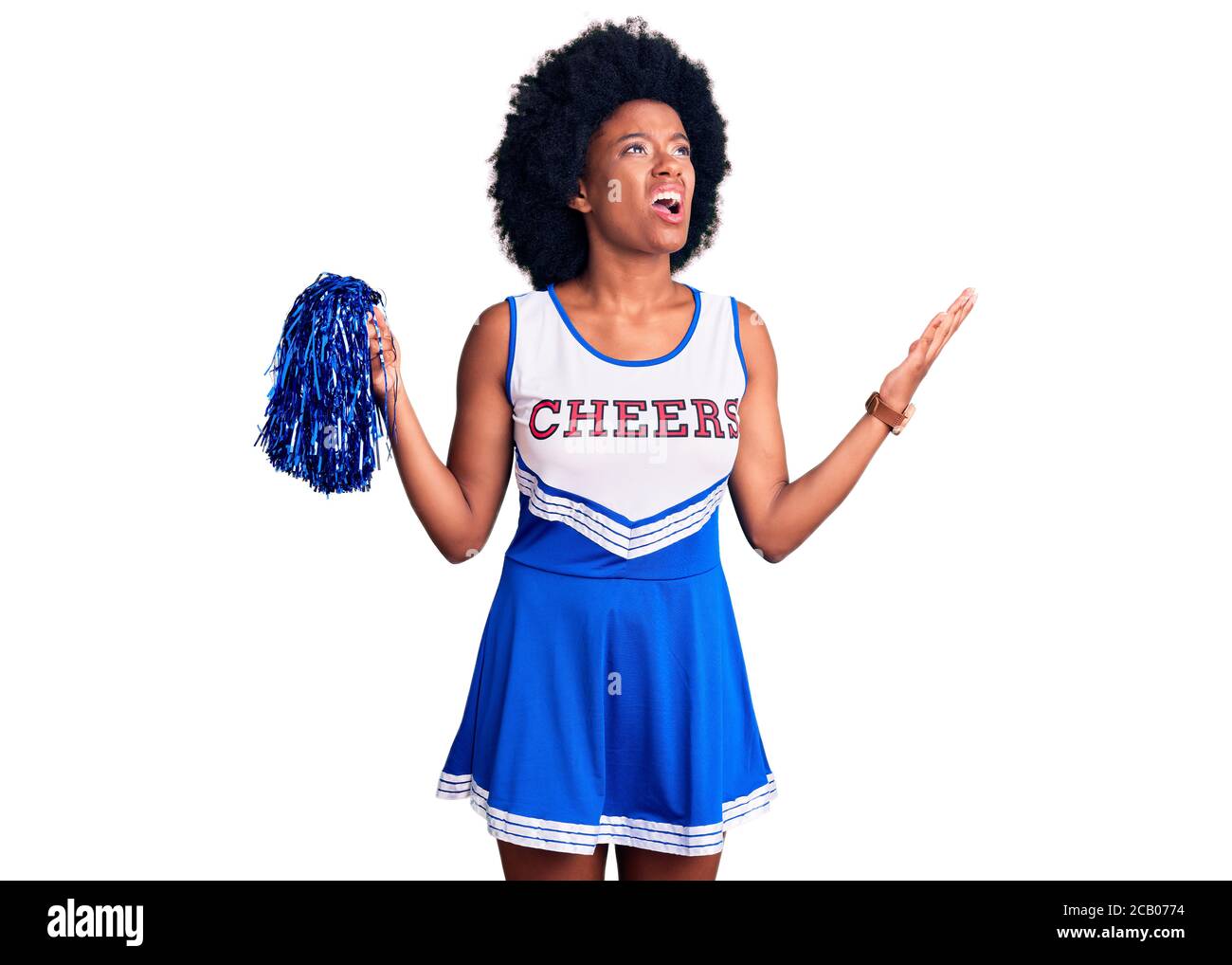Young african american woman wearing cheerleader uniform holding pompom ...