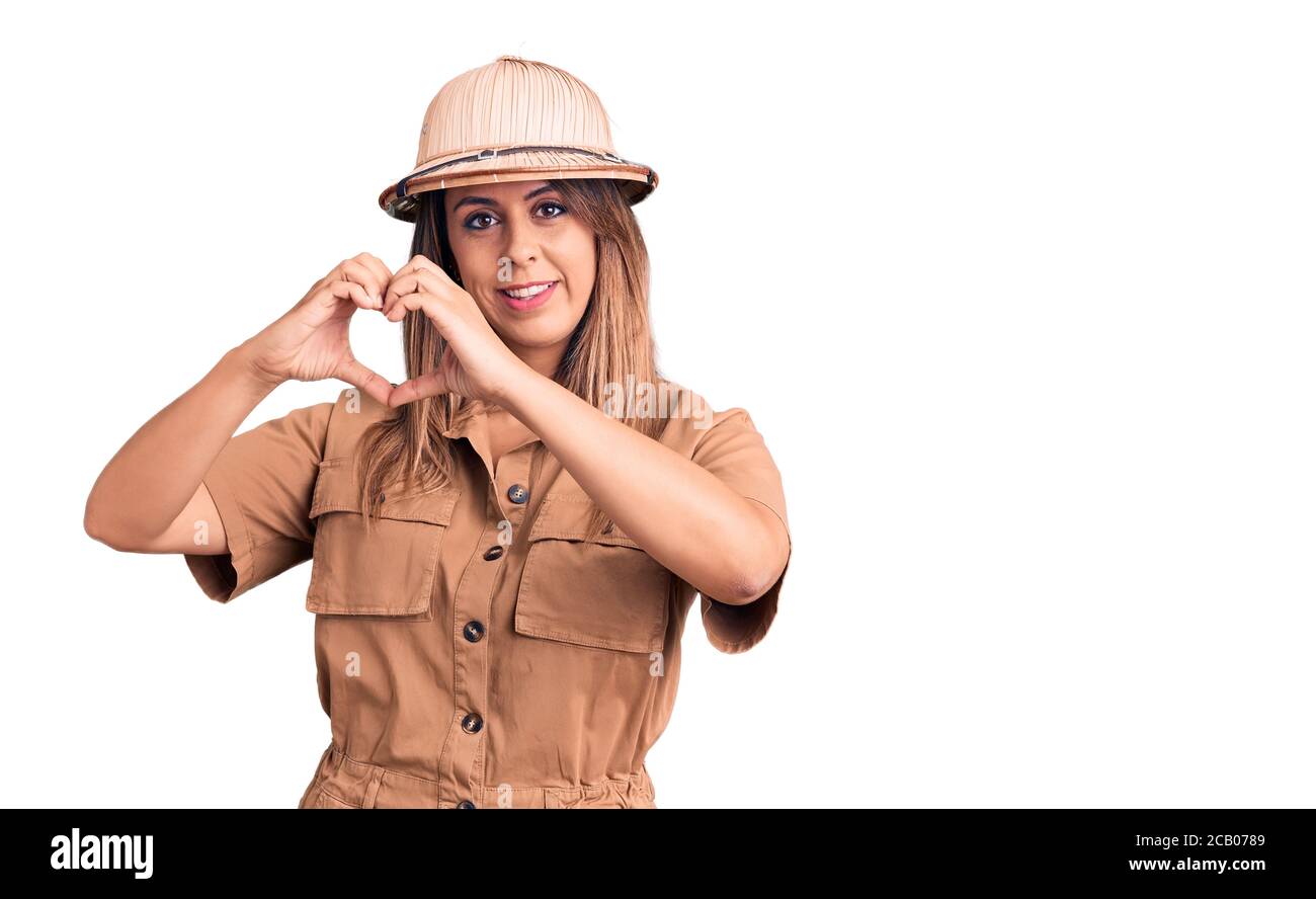Young beautiful woman wearing explorer hat smiling in love showing ...