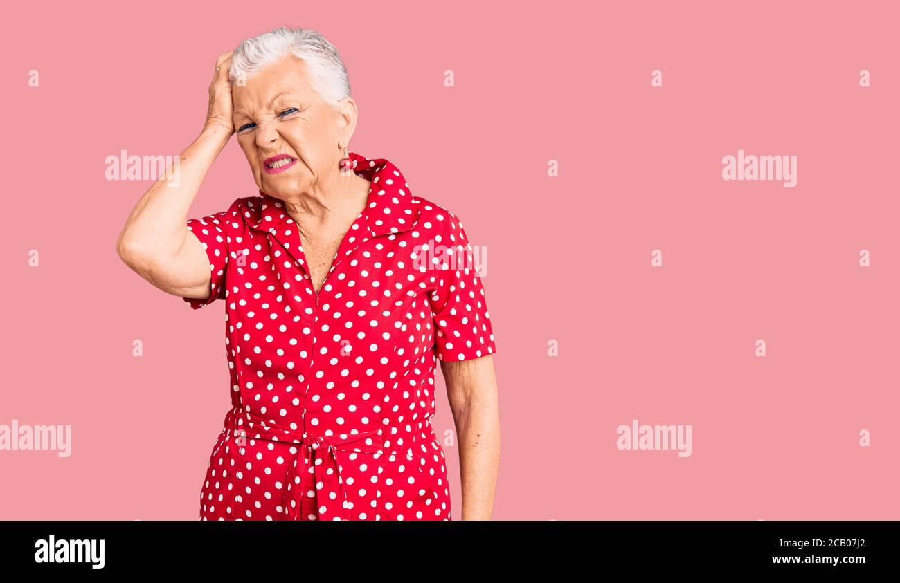 Senior beautiful woman with blue eyes and grey hair wearing a red ...
