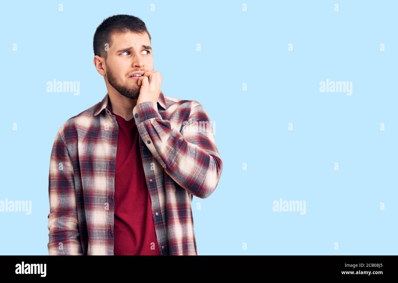 Young handsome man wearing casual shirt looking stressed and nervous ...