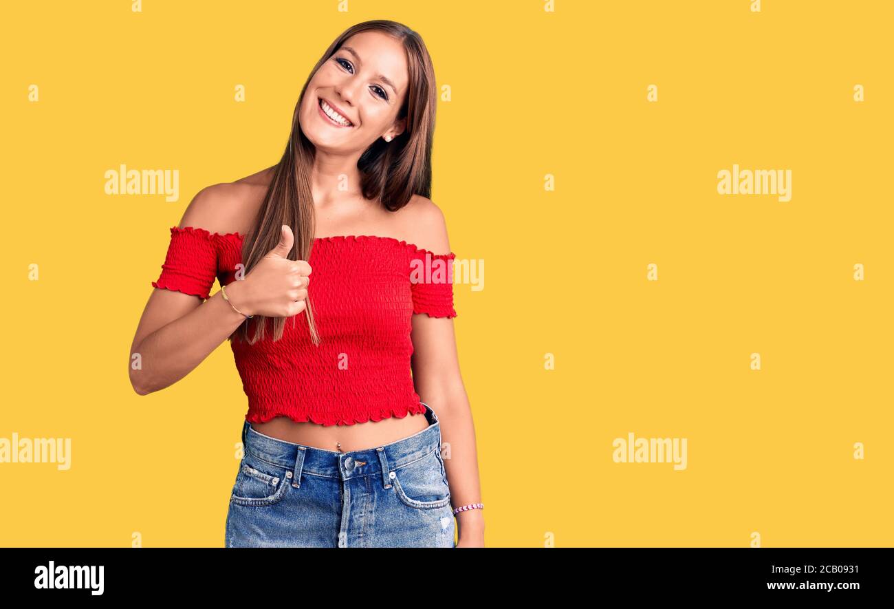 Young beautiful hispanic woman wearing casual clothes doing happy ...