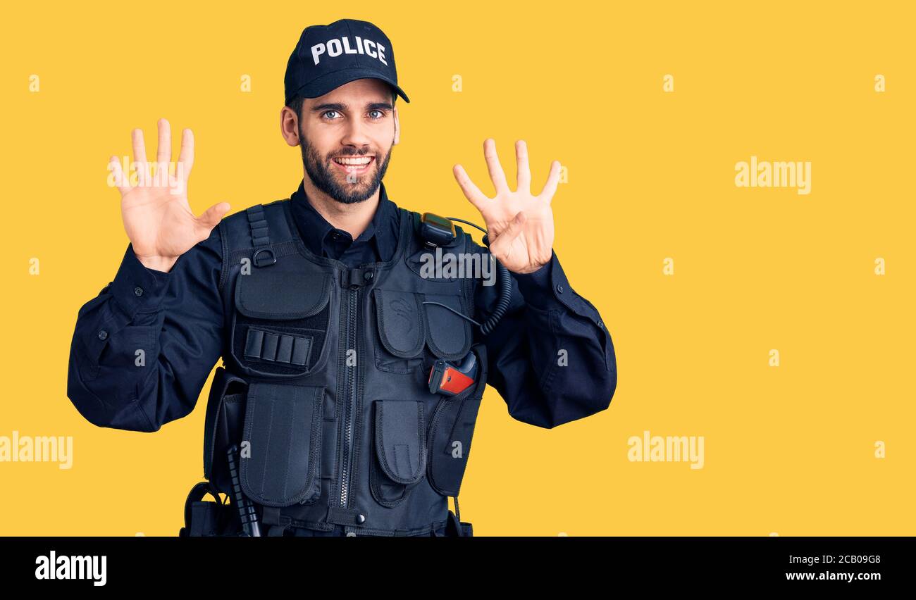 Young handsome man with beard wearing police uniform showing and ...