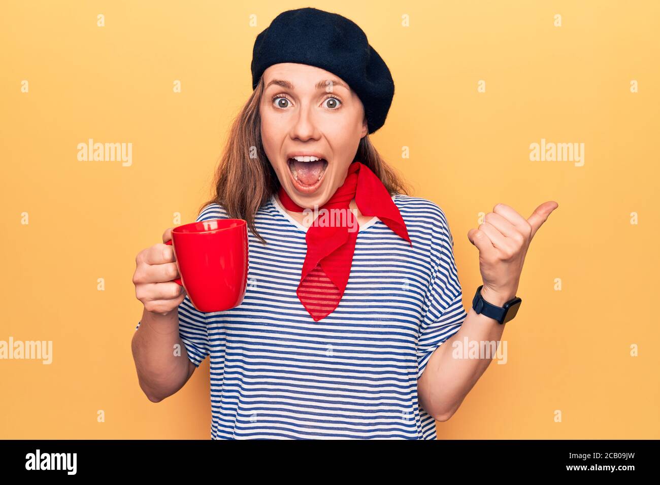 Young beautiful blonde woman wearing fashion beret drinking a cup of ...