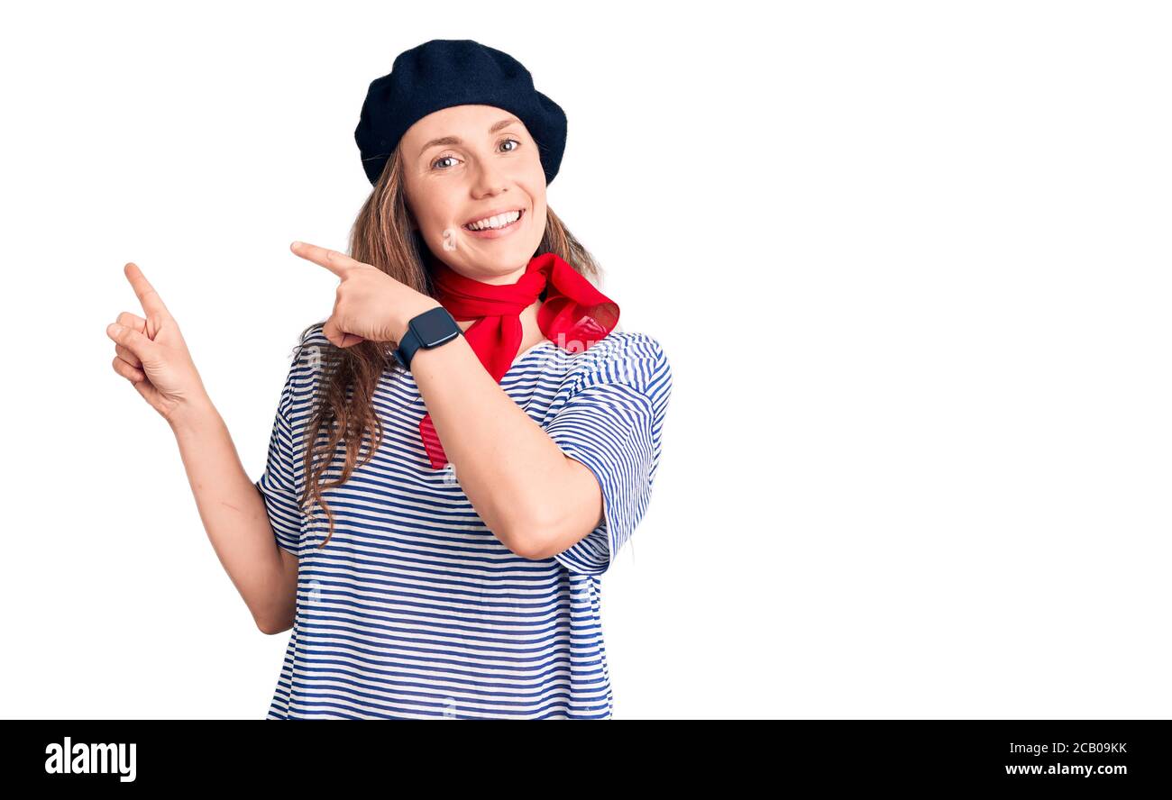 Young beautiful blonde woman wearing french beret and striped t-shirt ...