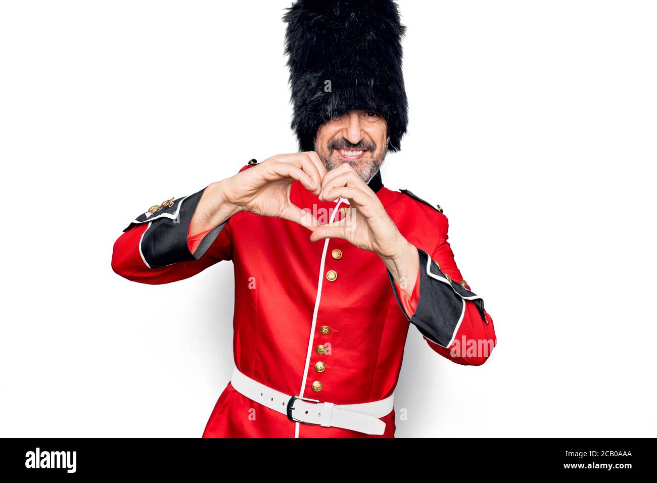 Middle age handsome wales guard man wearing traditional uniform over ...