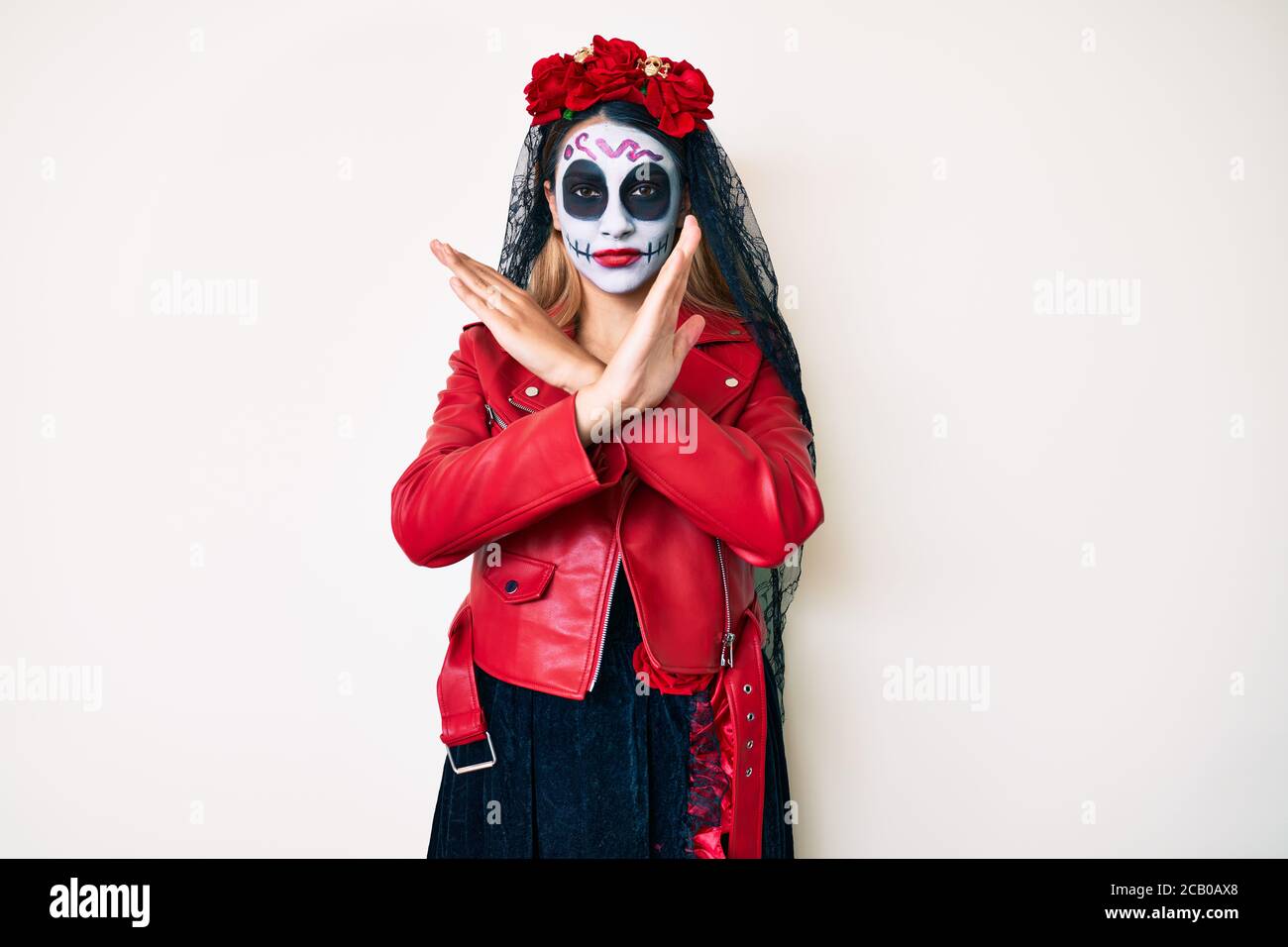 Woman wearing day of the dead costume over white rejection expression ...