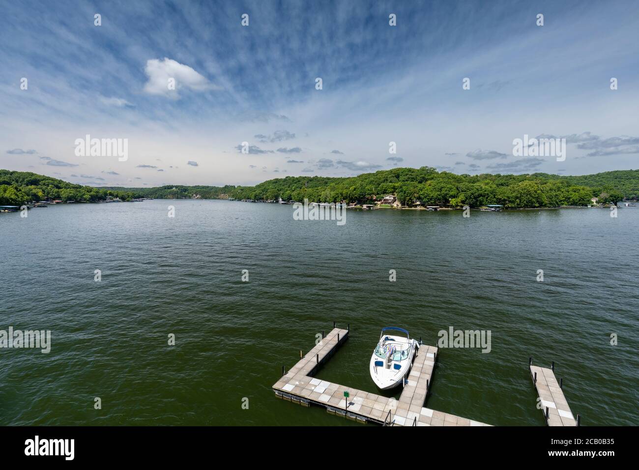 A scenic lake with a boat at dock Stock Photo - Alamy