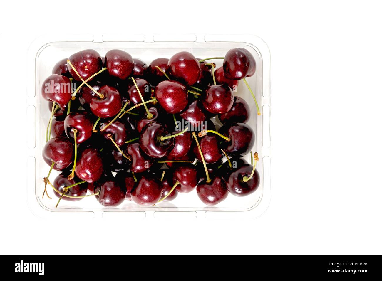 Cherries in plastic container isolated on white background directly ...