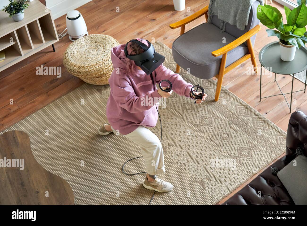 Teen girl wear vr headset play virtual reality modern game at home, top ...