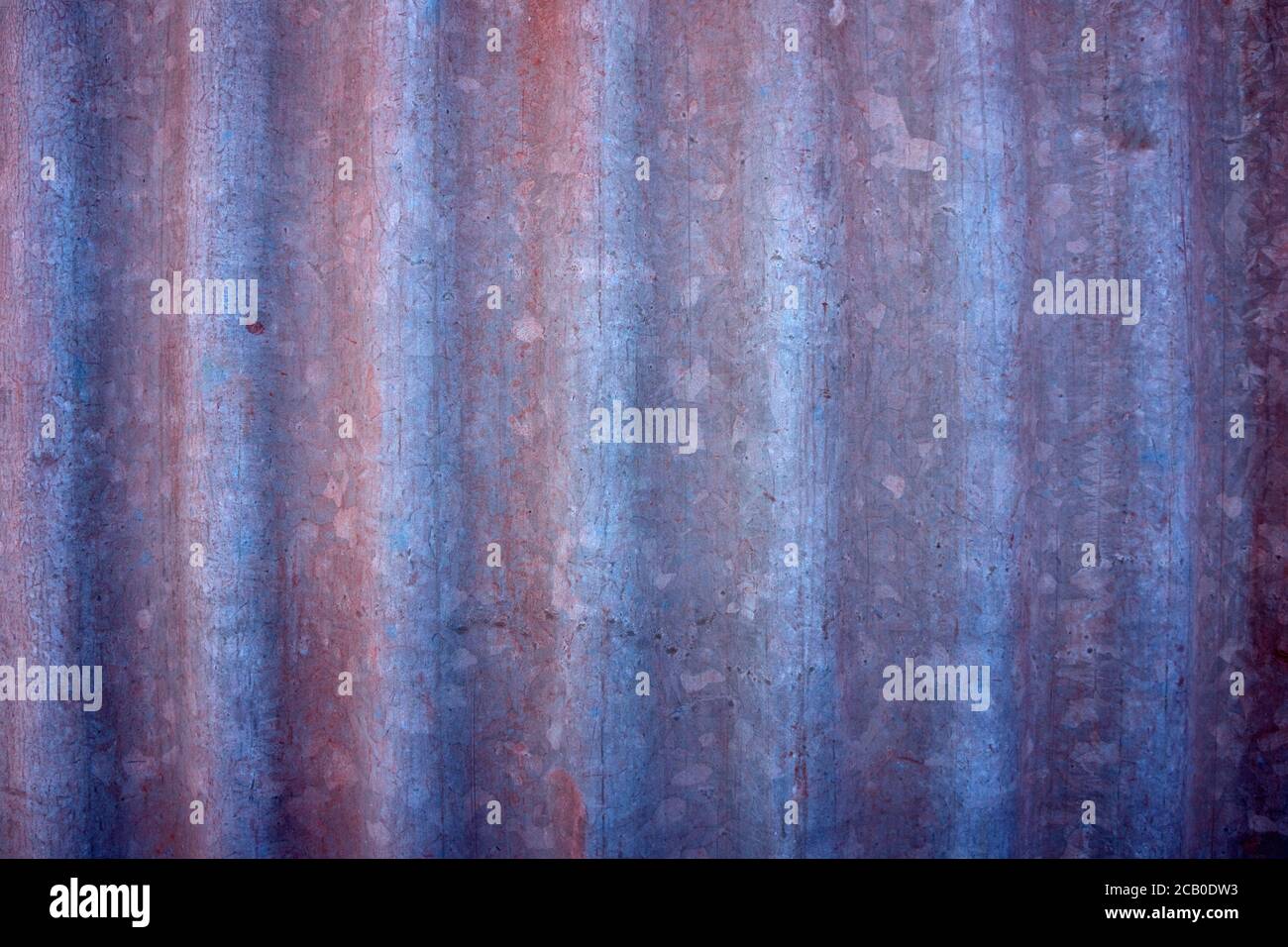 Red background texture on a tin metal sheet with a flow of abstract ...